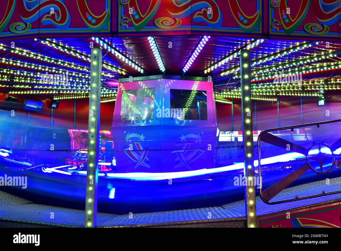 The Waltzer traditional fairground ride at night Stock Photo - Alamy