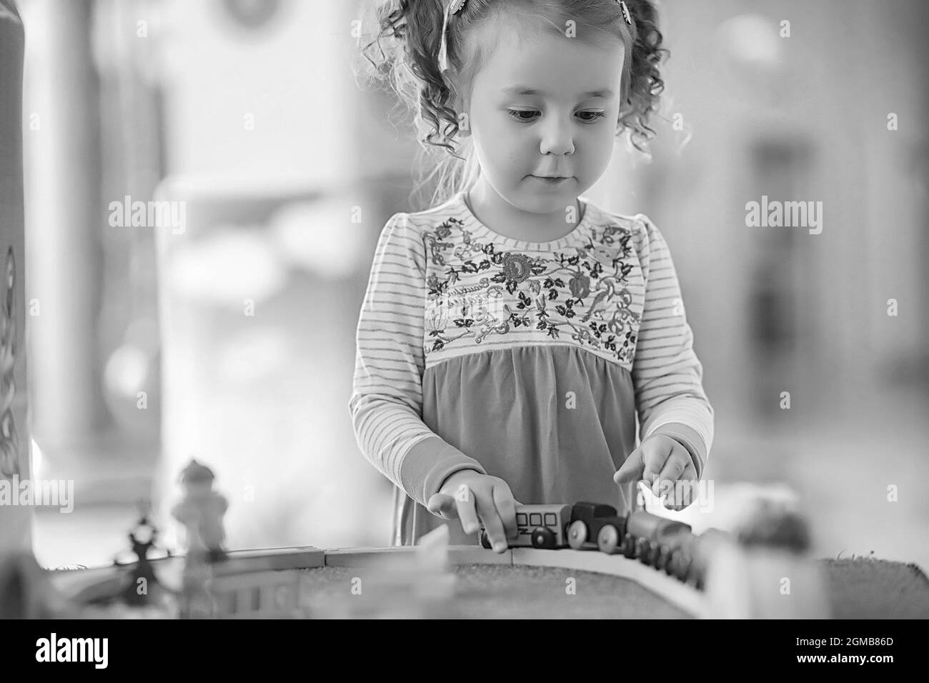 Child in the children's room. The kid is sitting on the windowsill at ...