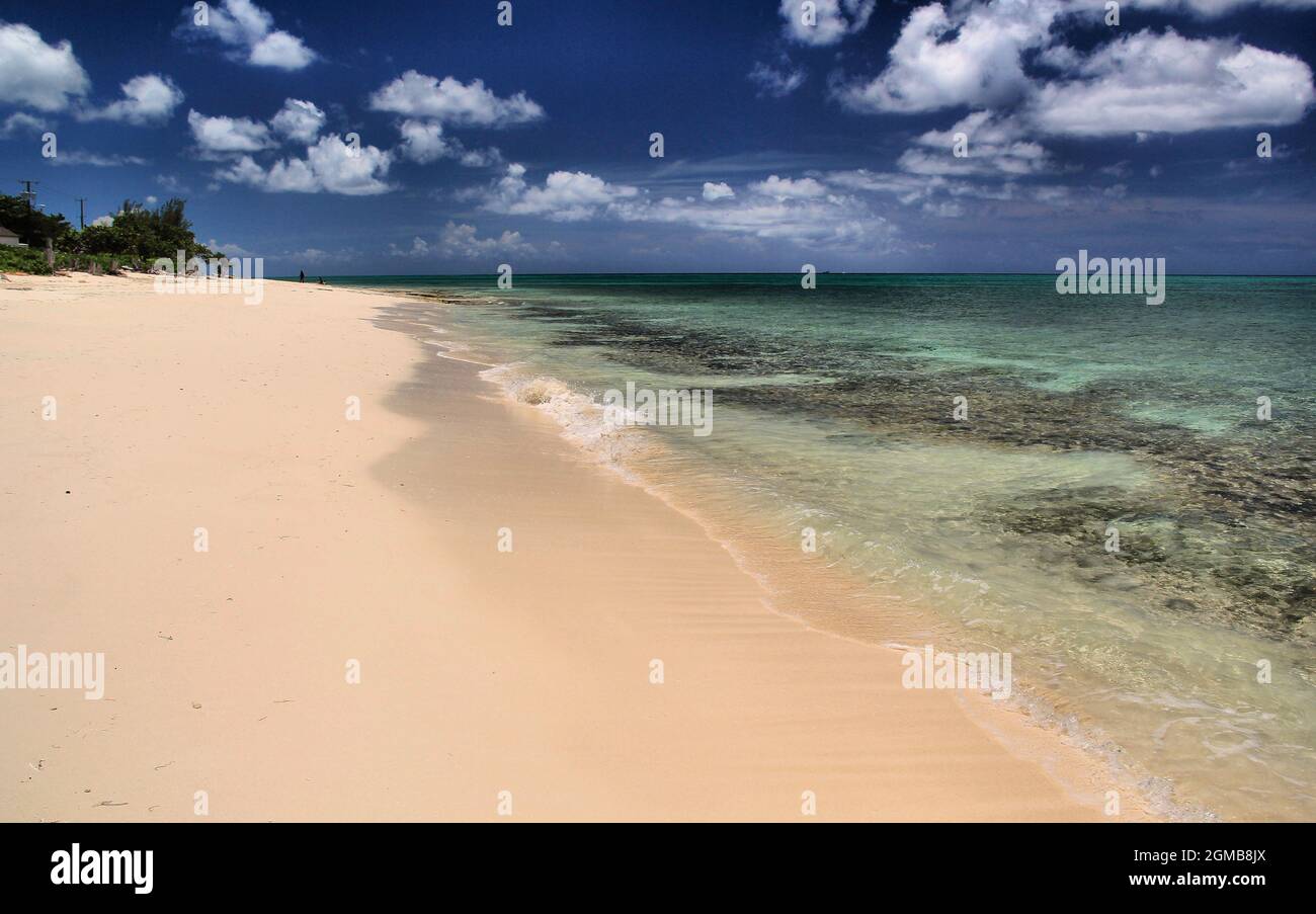 Tropical secluded private beach with blue skies, white sand and crystal ...