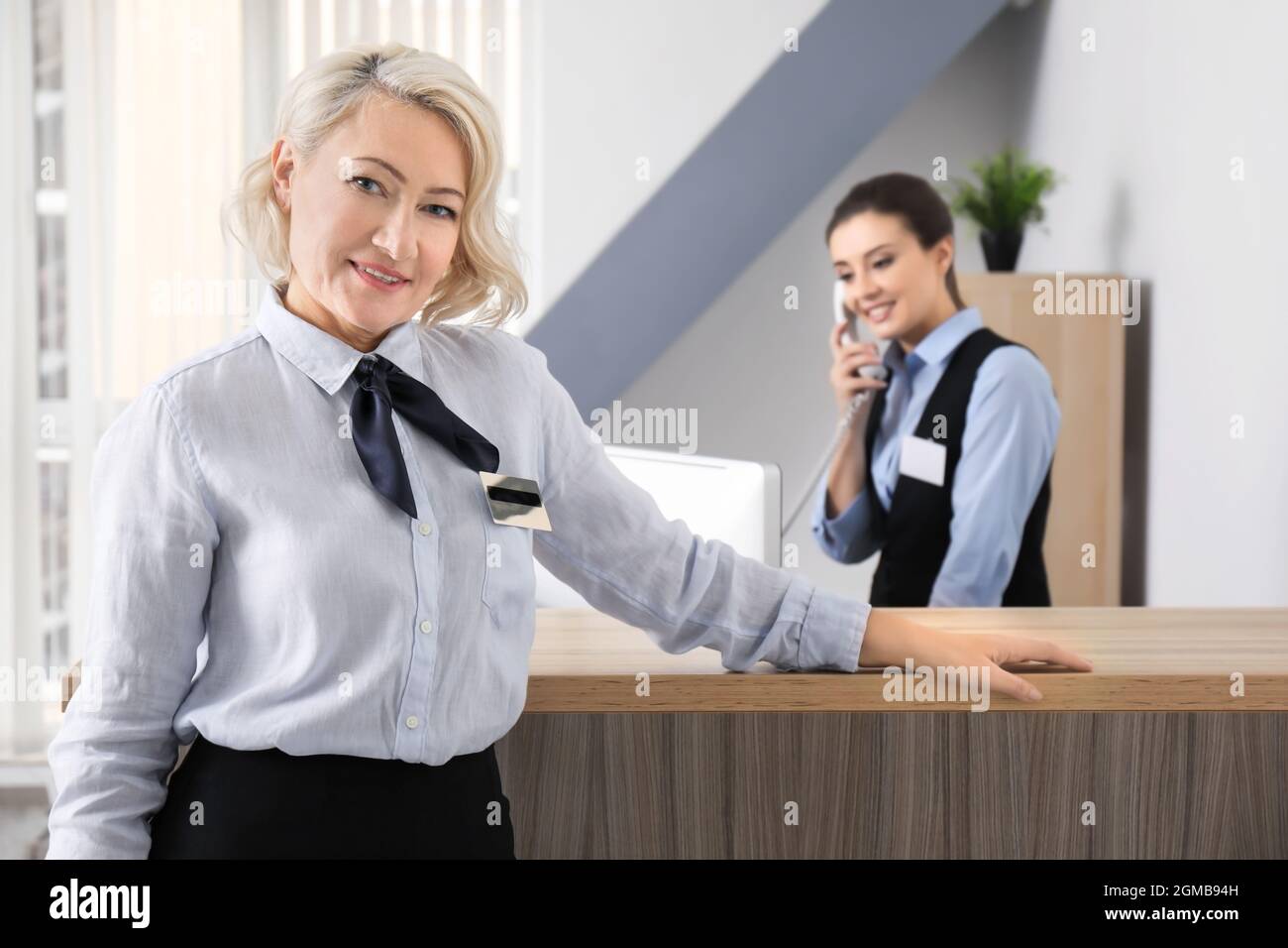 Female hotel receptionist at workplace Stock Photo - Alamy