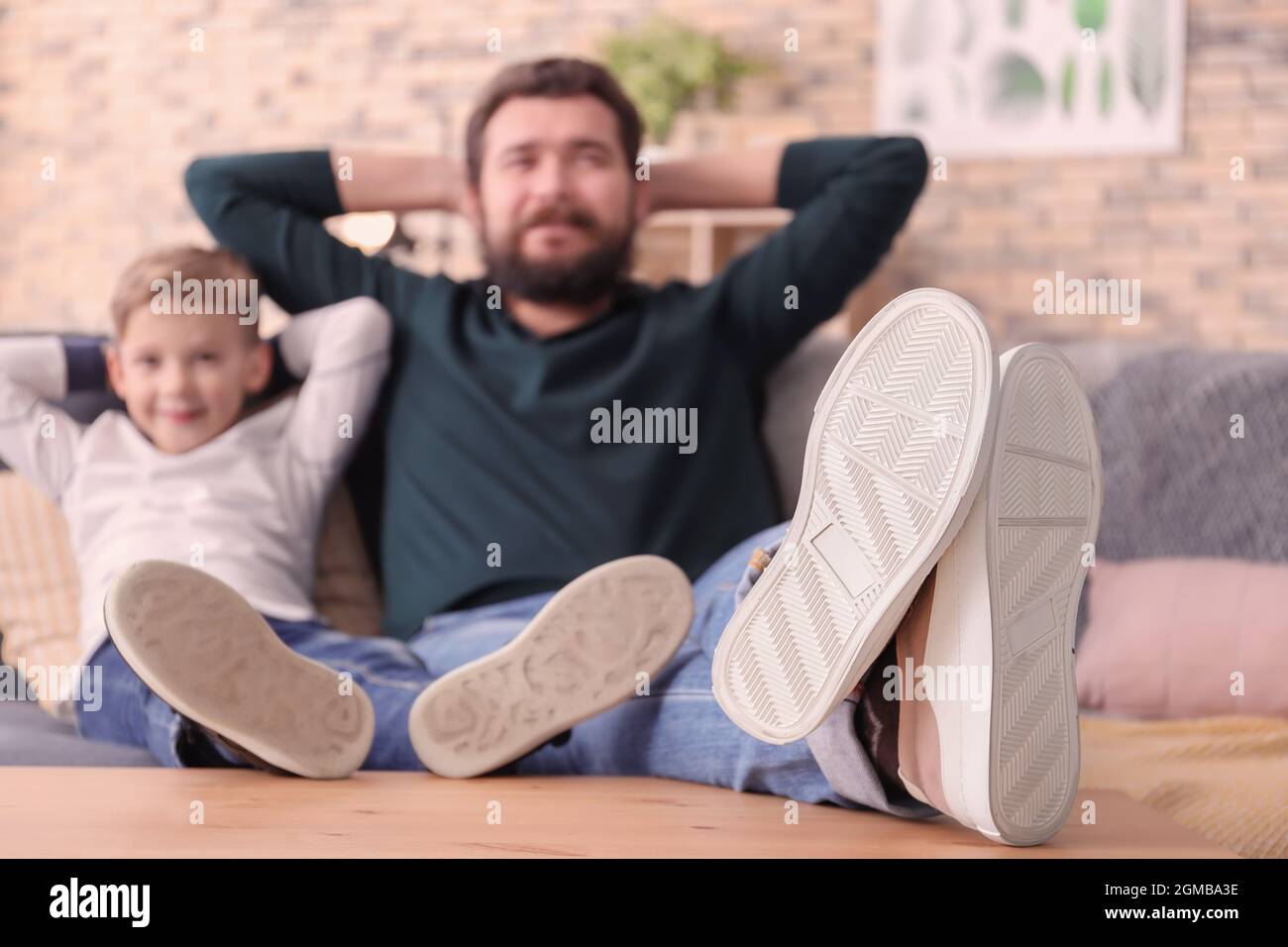 Father and son watching TV together at home Stock Photo - Alamy