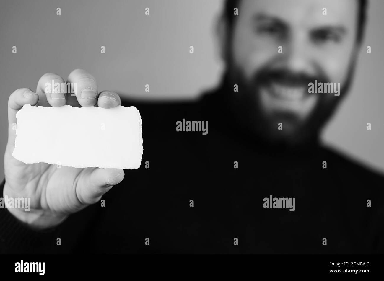 a small white piece of paper in his hand man Stock Photo - Alamy