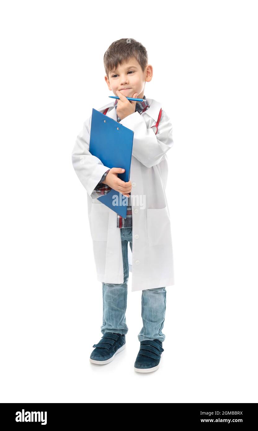 Cute little boy in doctor uniform with clipboard on white background ...