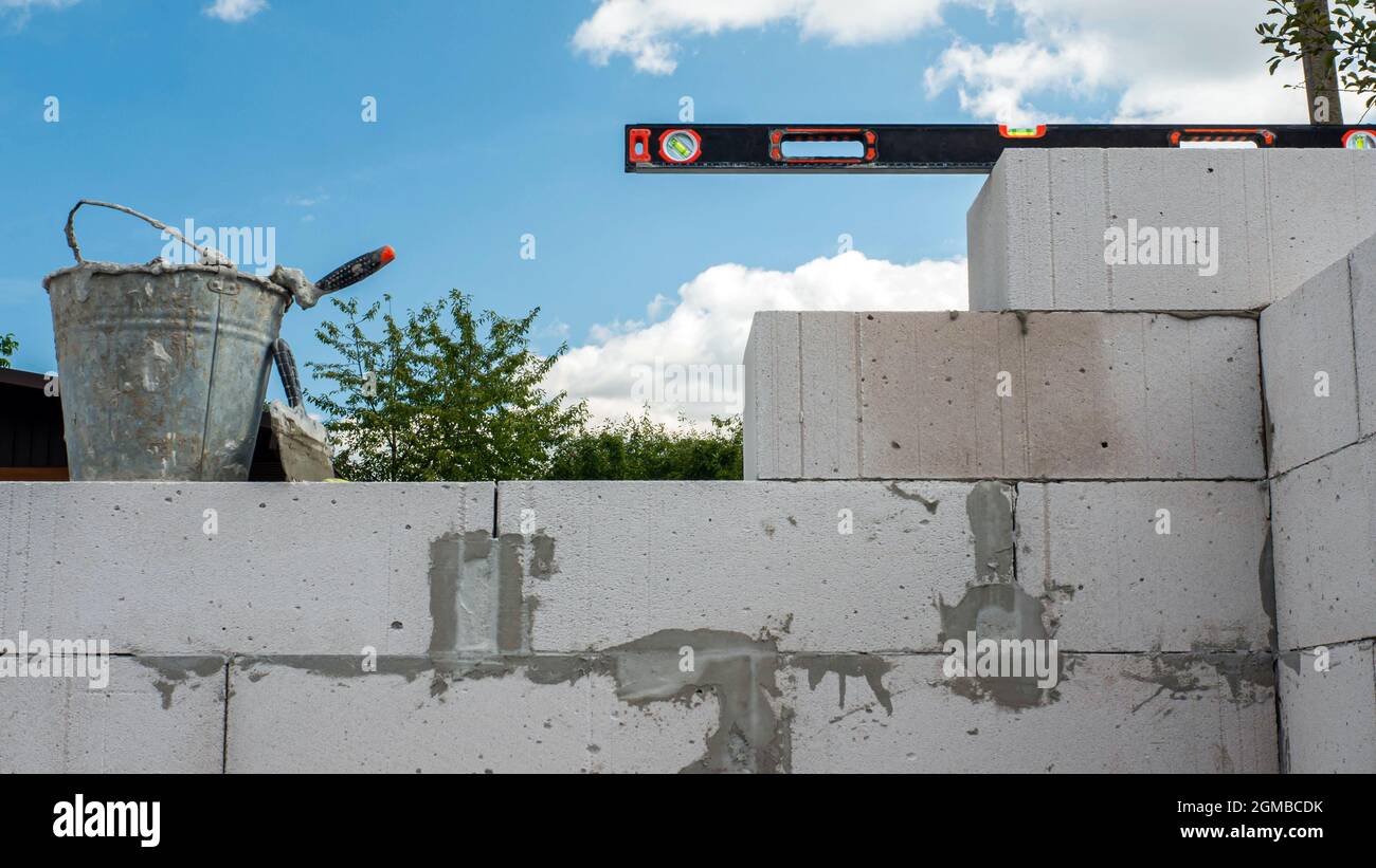 Building a house from a white block, building tools on a brick ...