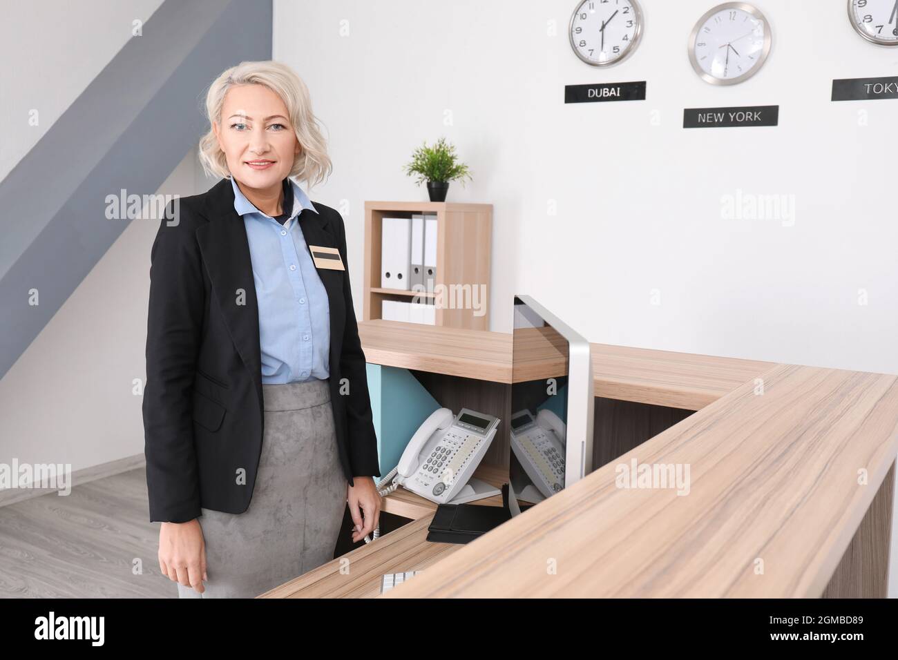 Female hotel receptionist at workplace Stock Photo - Alamy