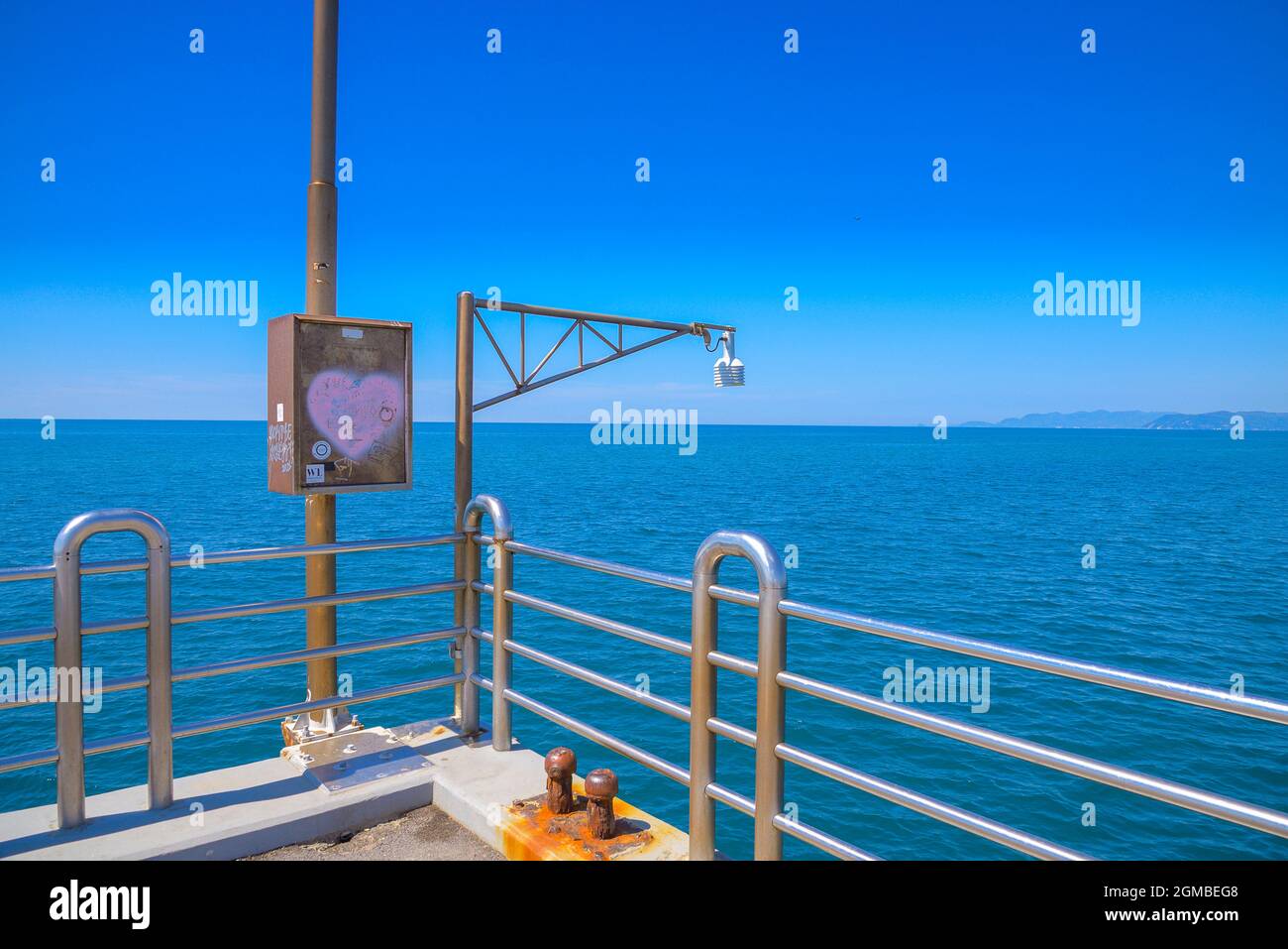 a painted pink heart, seascape seen from the tourist wharf in Versilia ...