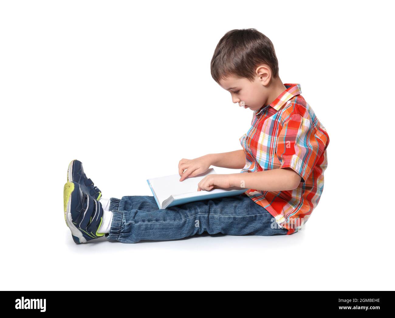 Cute little boy reading book on white background Stock Photo - Alamy
