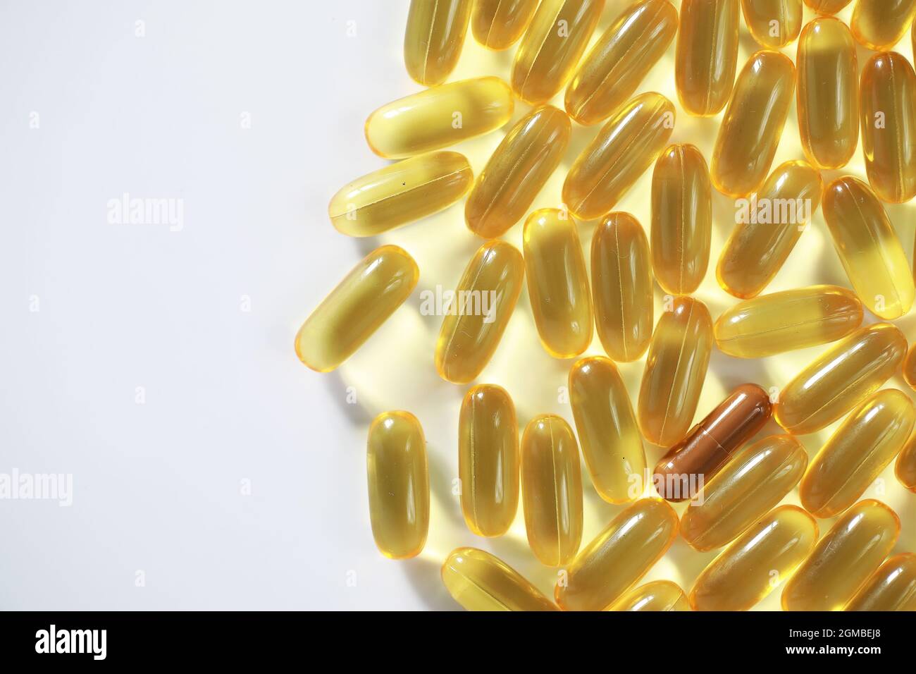 Medical medicines and supplements transparent capsules of yellow color ...