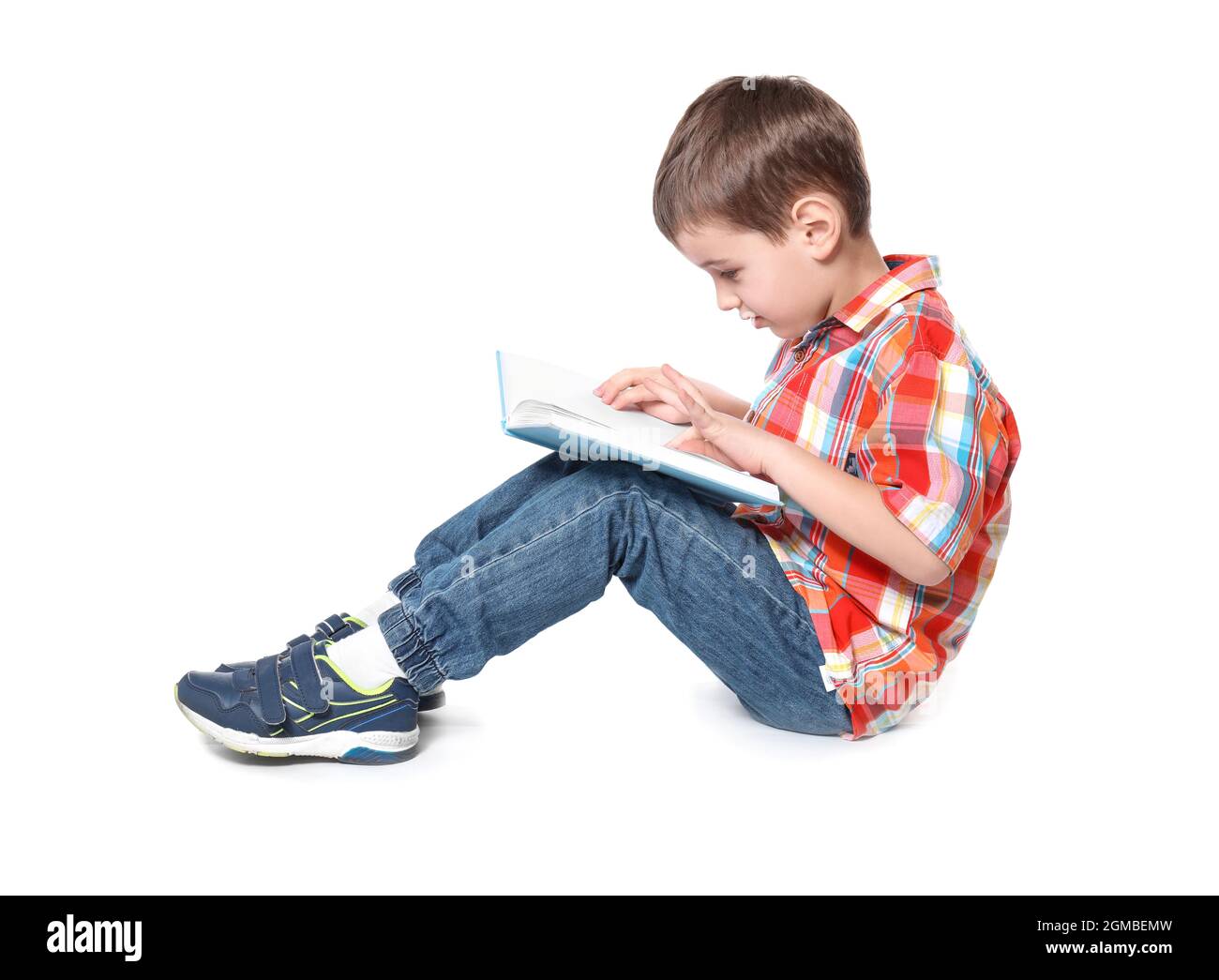 Cute little boy reading book on white background Stock Photo - Alamy
