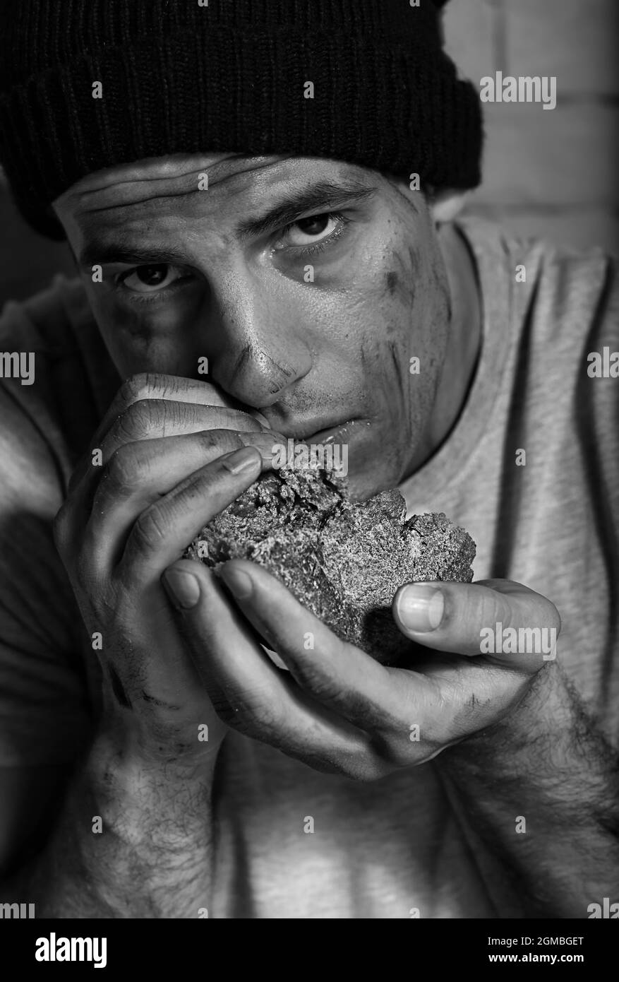 Hungry poor man eating piece of bread Stock Photo - Alamy