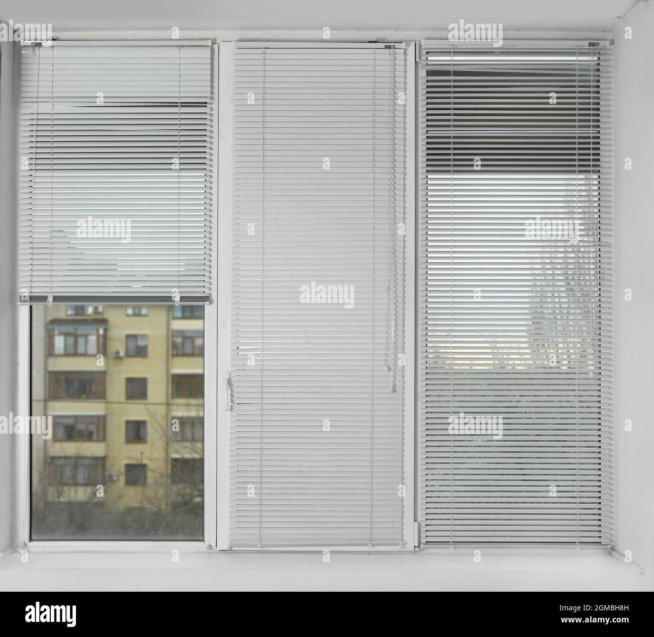 Beautiful urban view from window with venetian blinds Stock Photo - Alamy