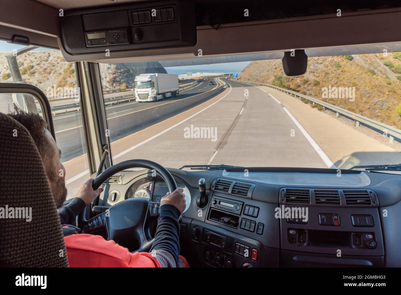 Truck driver driving on the highway, seen from inside the cab Stock ...