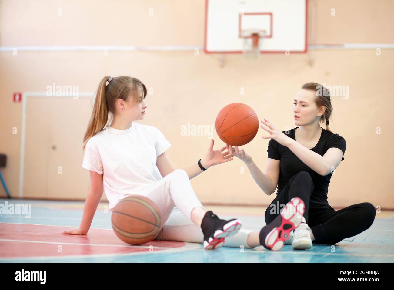 Girl young student in the gym playing a basketball Stock Photo - Alamy