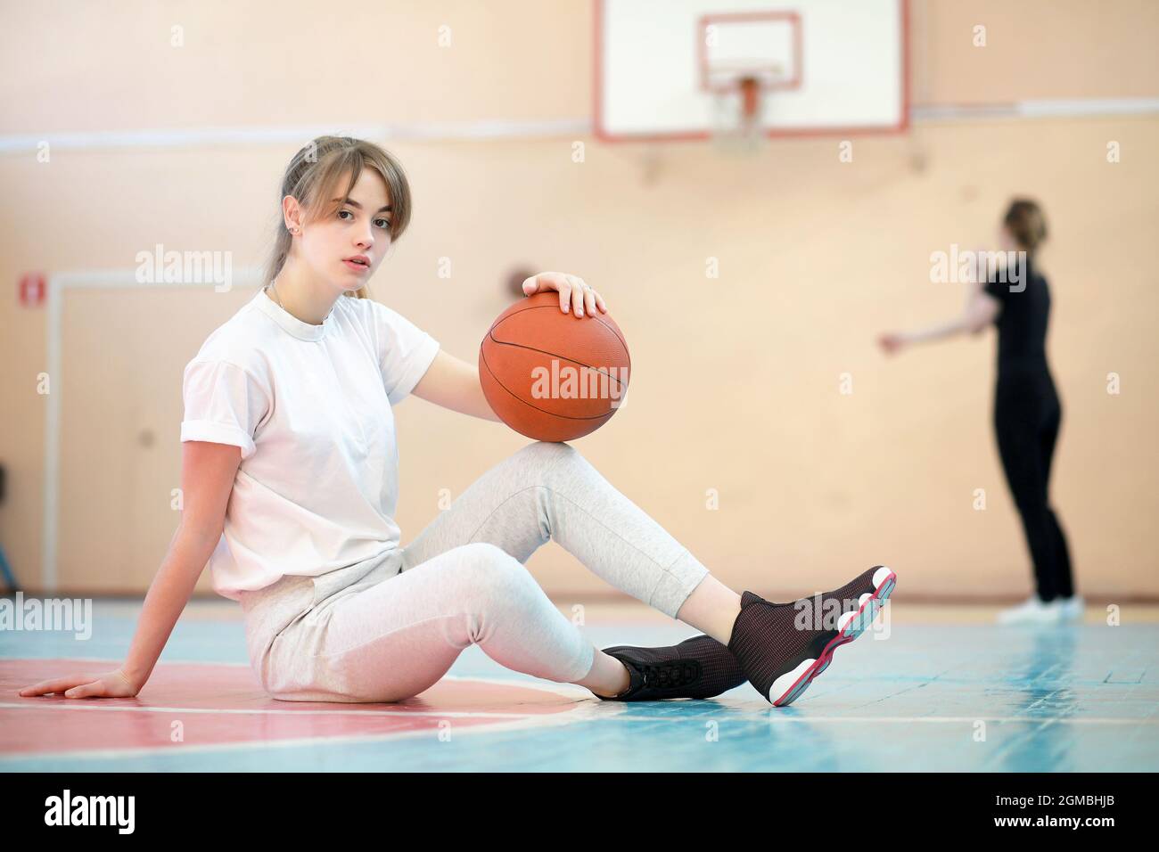 Girl young student in the gym playing a basketball Stock Photo - Alamy