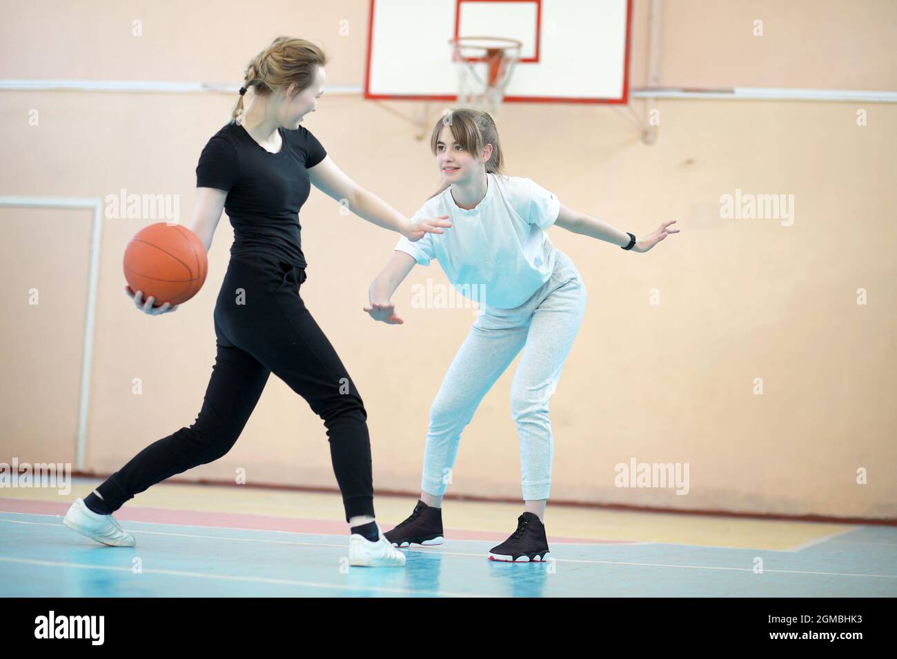 Girl young student in the gym playing a basketball Stock Photo - Alamy