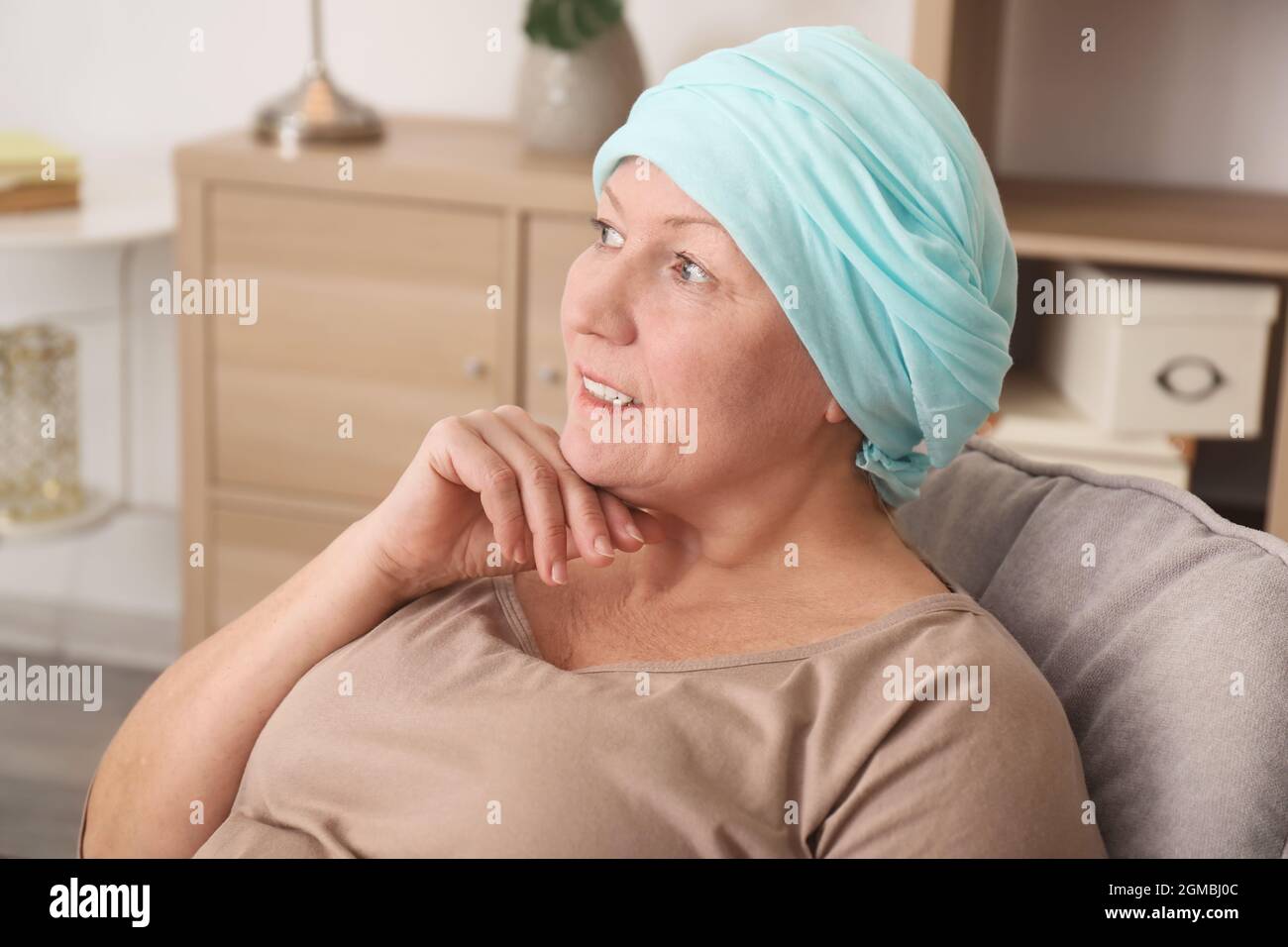 Mature woman with cancer in headscarf indoors Stock Photo - Alamy