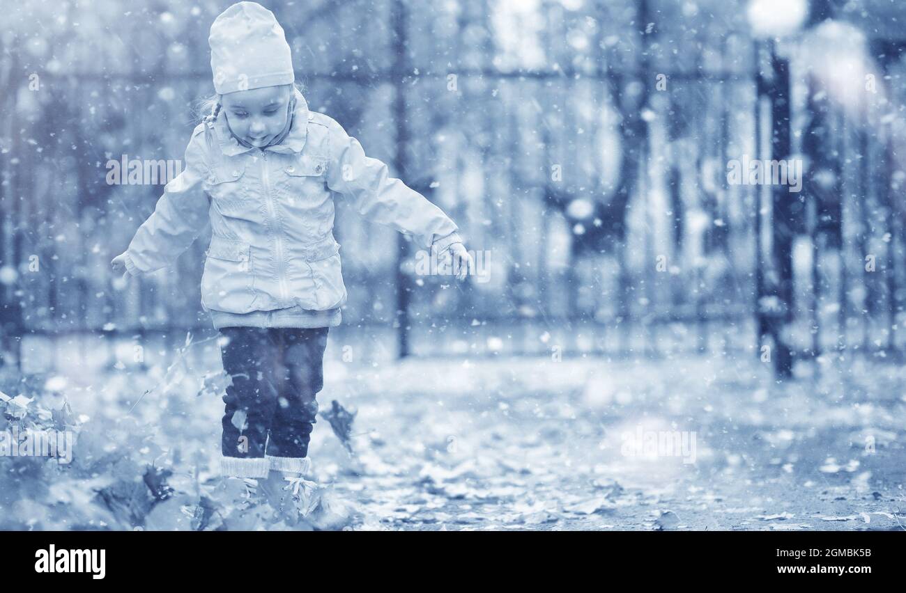 Kids walk in the park with first snow Stock Photo - Alamy