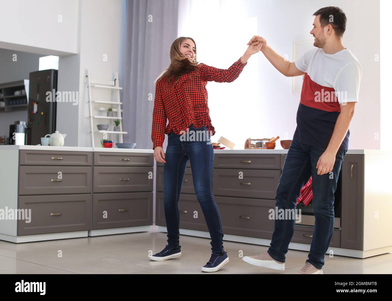 Cute young lovely couple dancing at home Stock Photo - Alamy