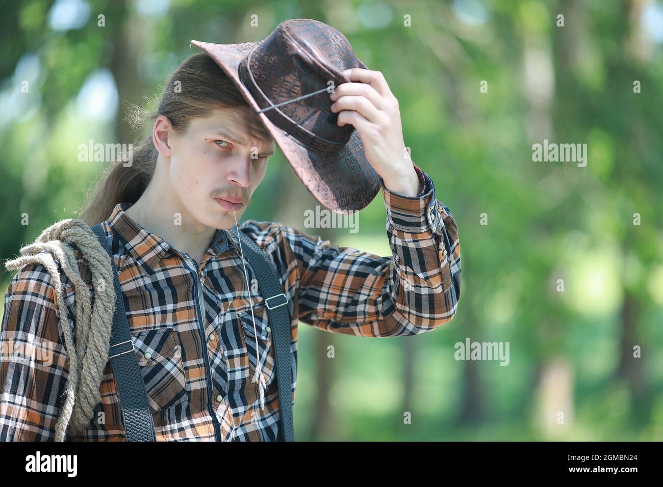 Cowboy with hat in a field in autumn Stock Photo - Alamy