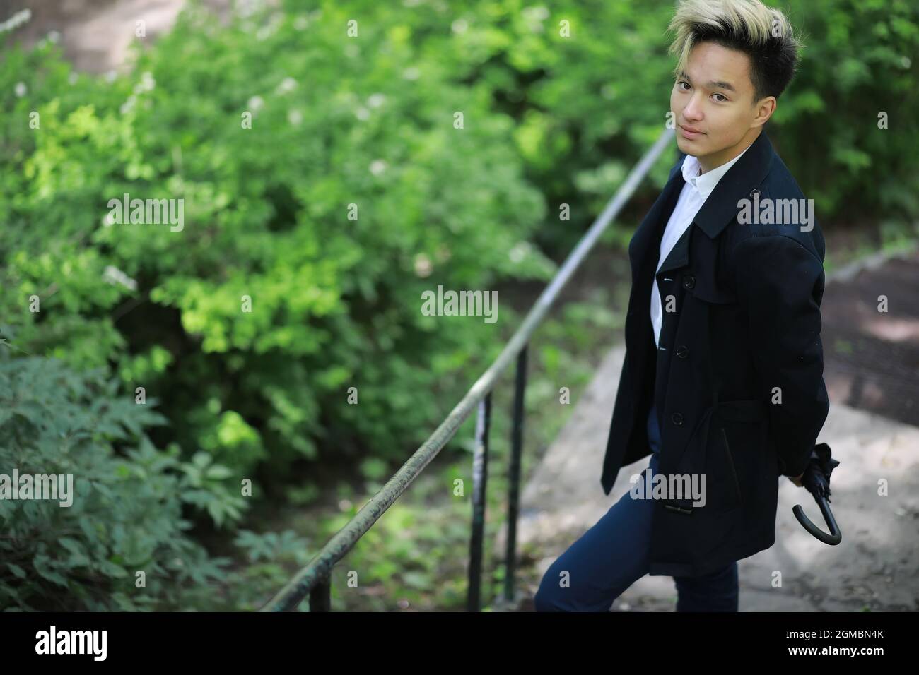 Spring Park in rainy weather and a young man with an umbrella Stock ...