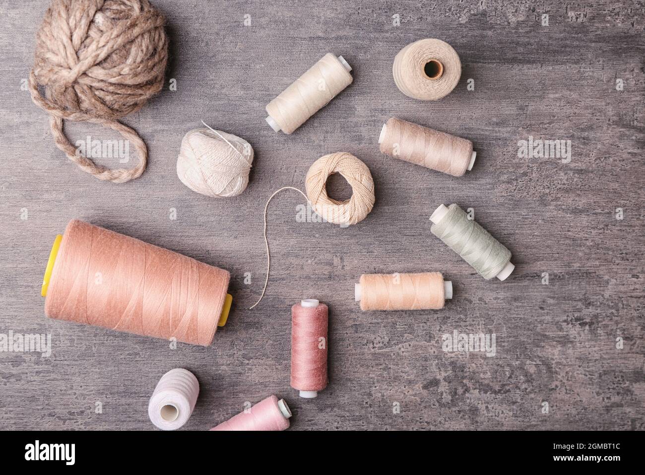 Different types of threads on grey background, top view Stock Photo - Alamy