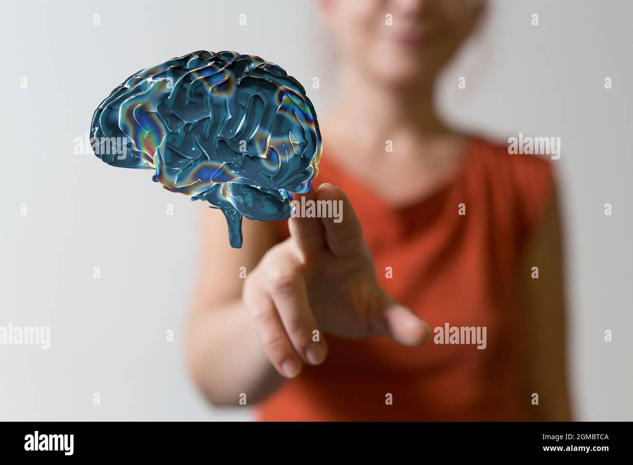3D rendering of brain with a female pointing on it from the background ...
