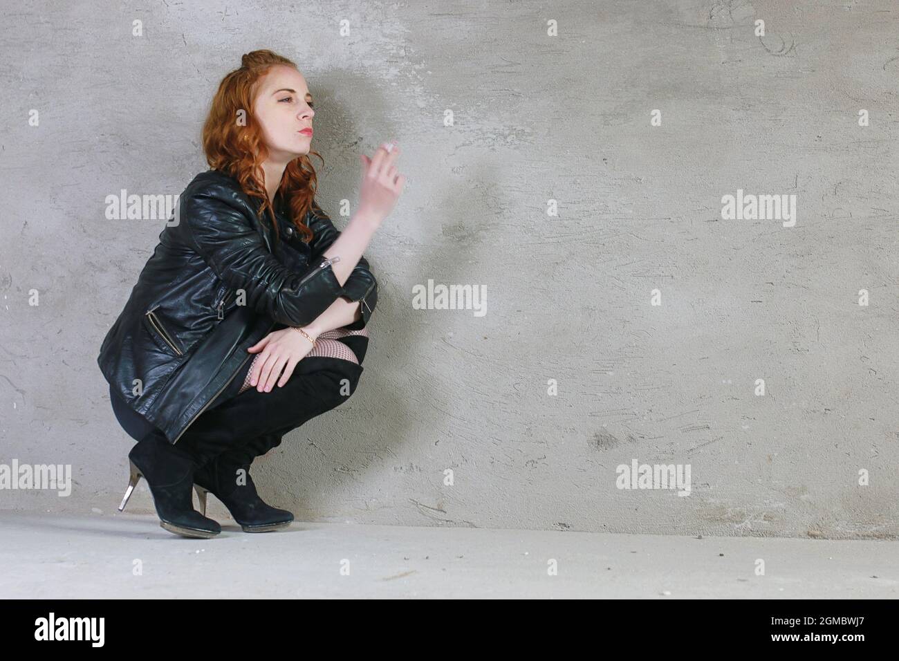 Girl addict in a leather jacket with a dose in a syringe prostitute ...