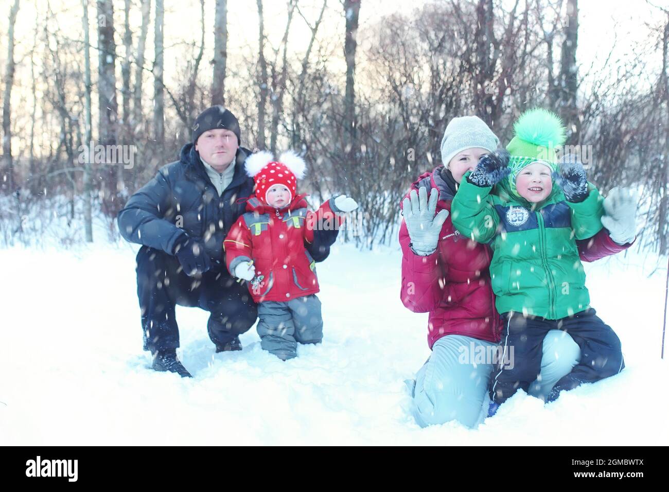 Family with children in the park in winter snow blizzard Stock Photo ...