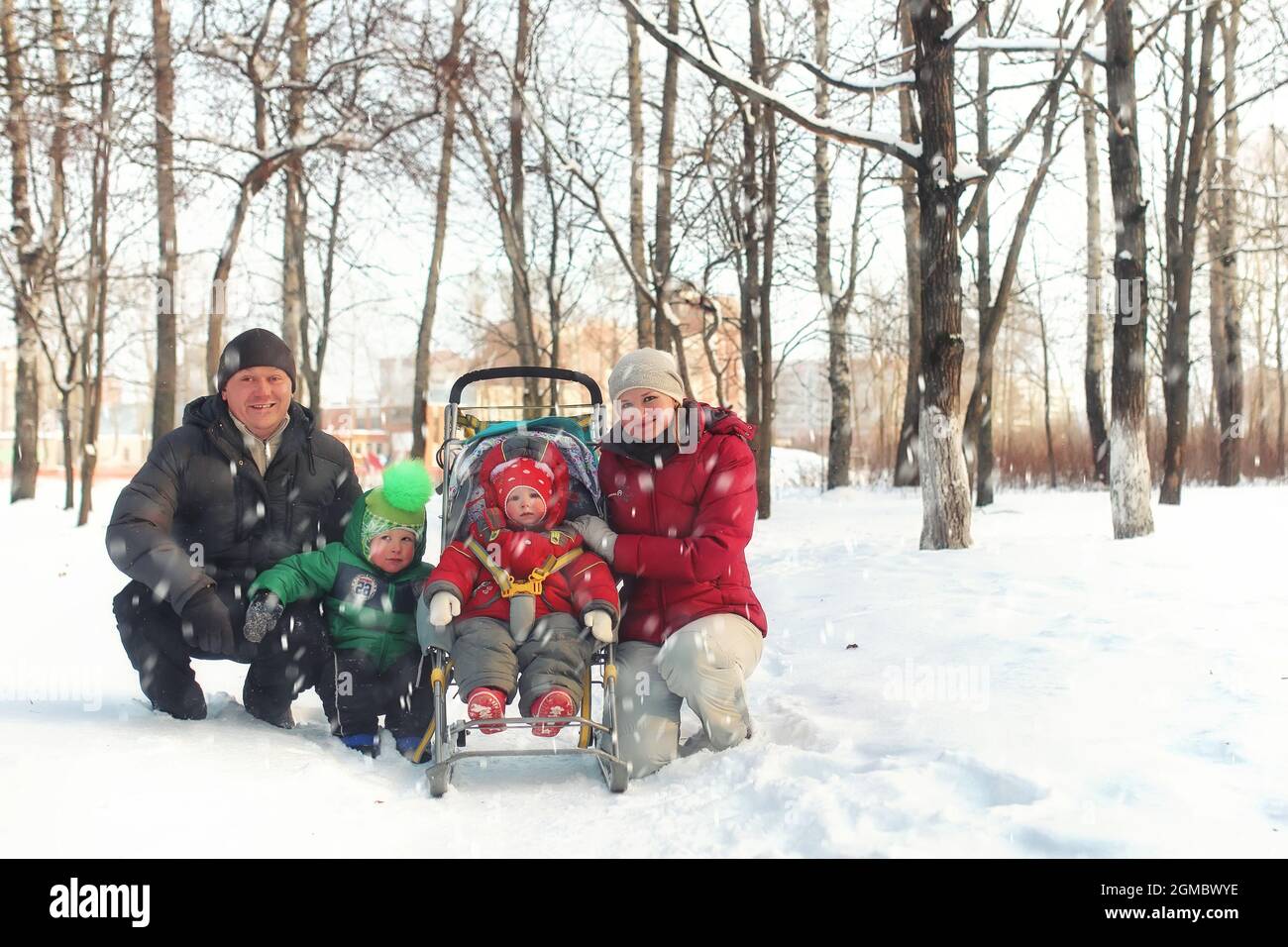 Family with children in the park in winter snow blizzard Stock Photo ...