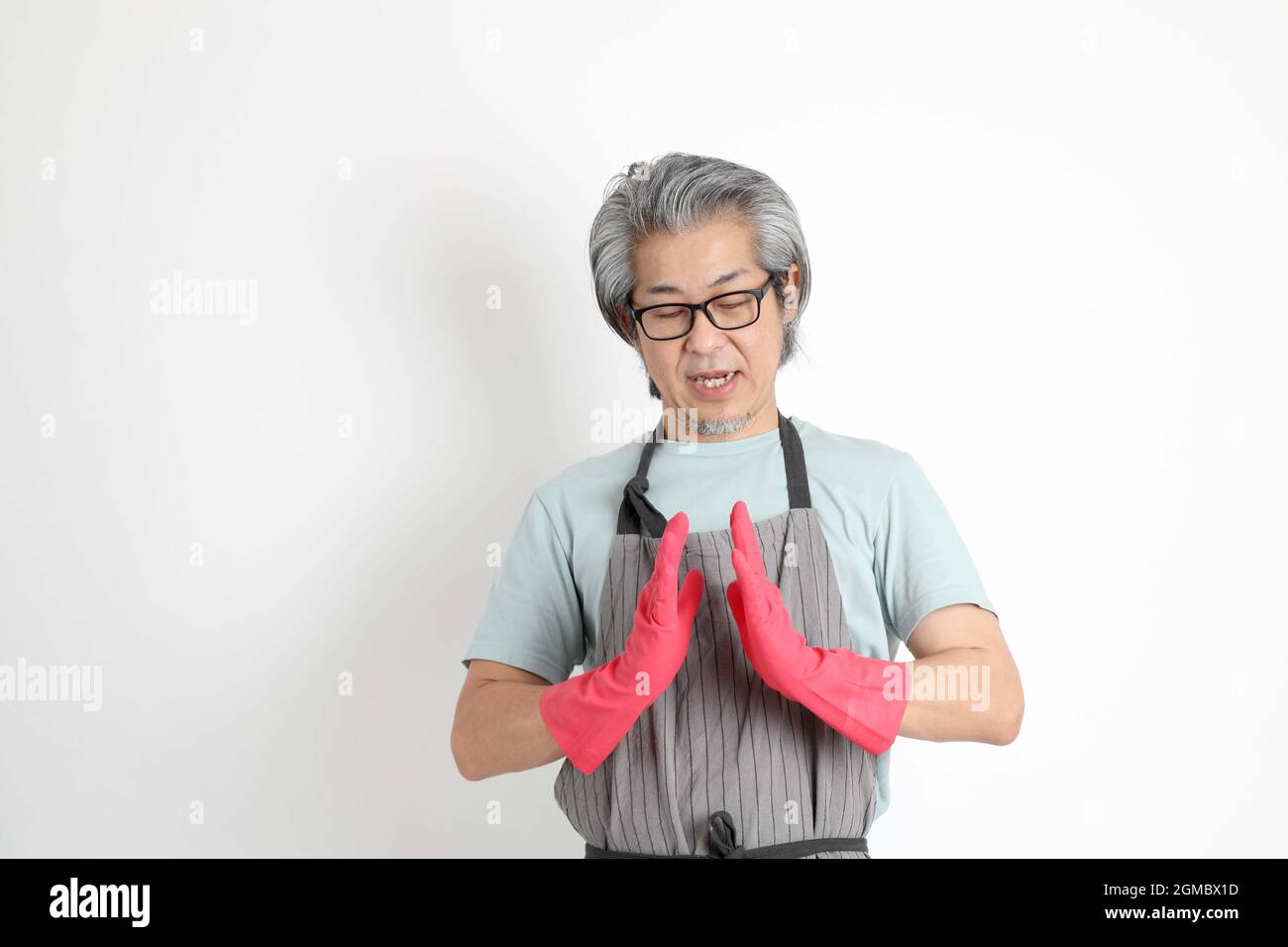 The senior Asian housekeeper standing on the white background Stock ...