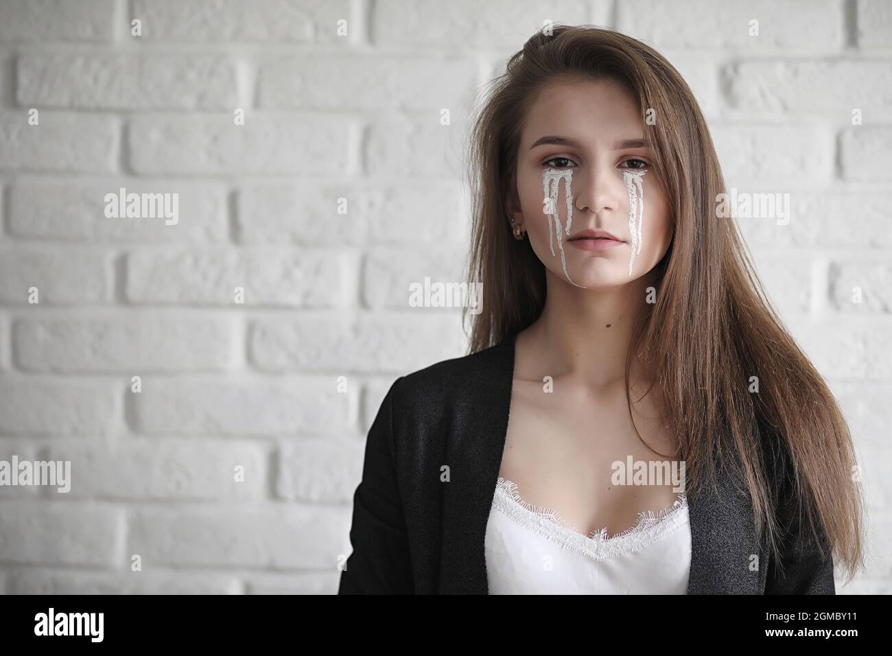Beautiful girl with tears in eyes. Young girl with painted tears posing ...