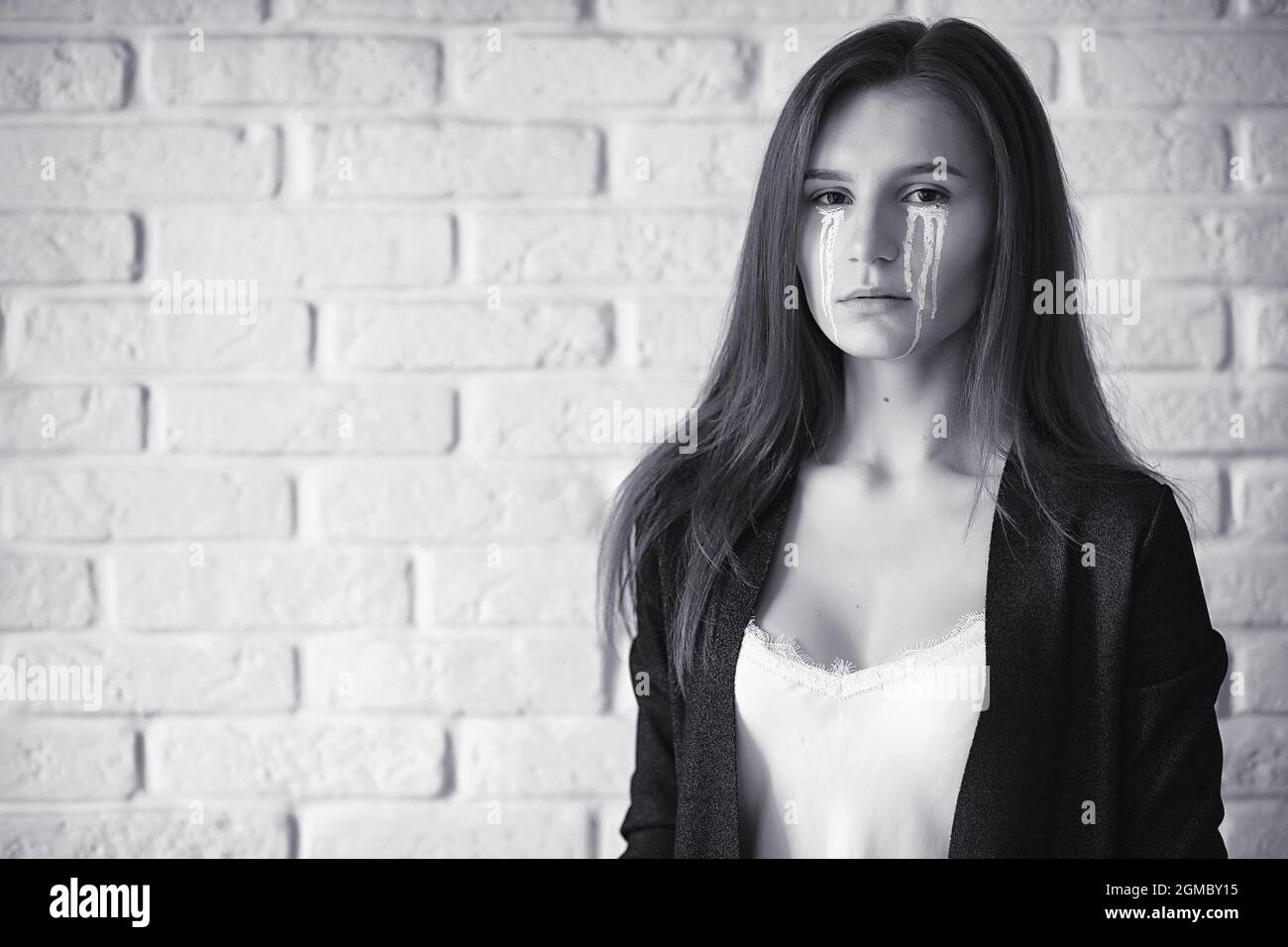 Beautiful girl with tears in eyes. Young girl with painted tears posing ...