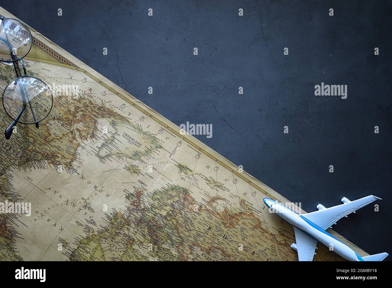 Travel concept. Map on the table and model aircraft Stock Photo - Alamy