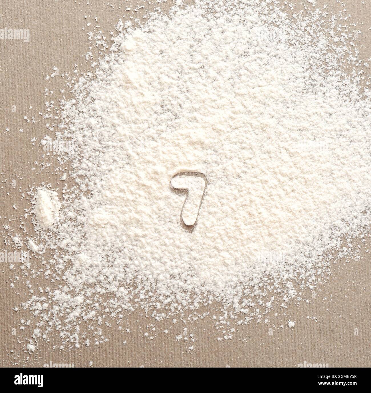 Silhouette of figure 7 on scattered flour Stock Photo - Alamy