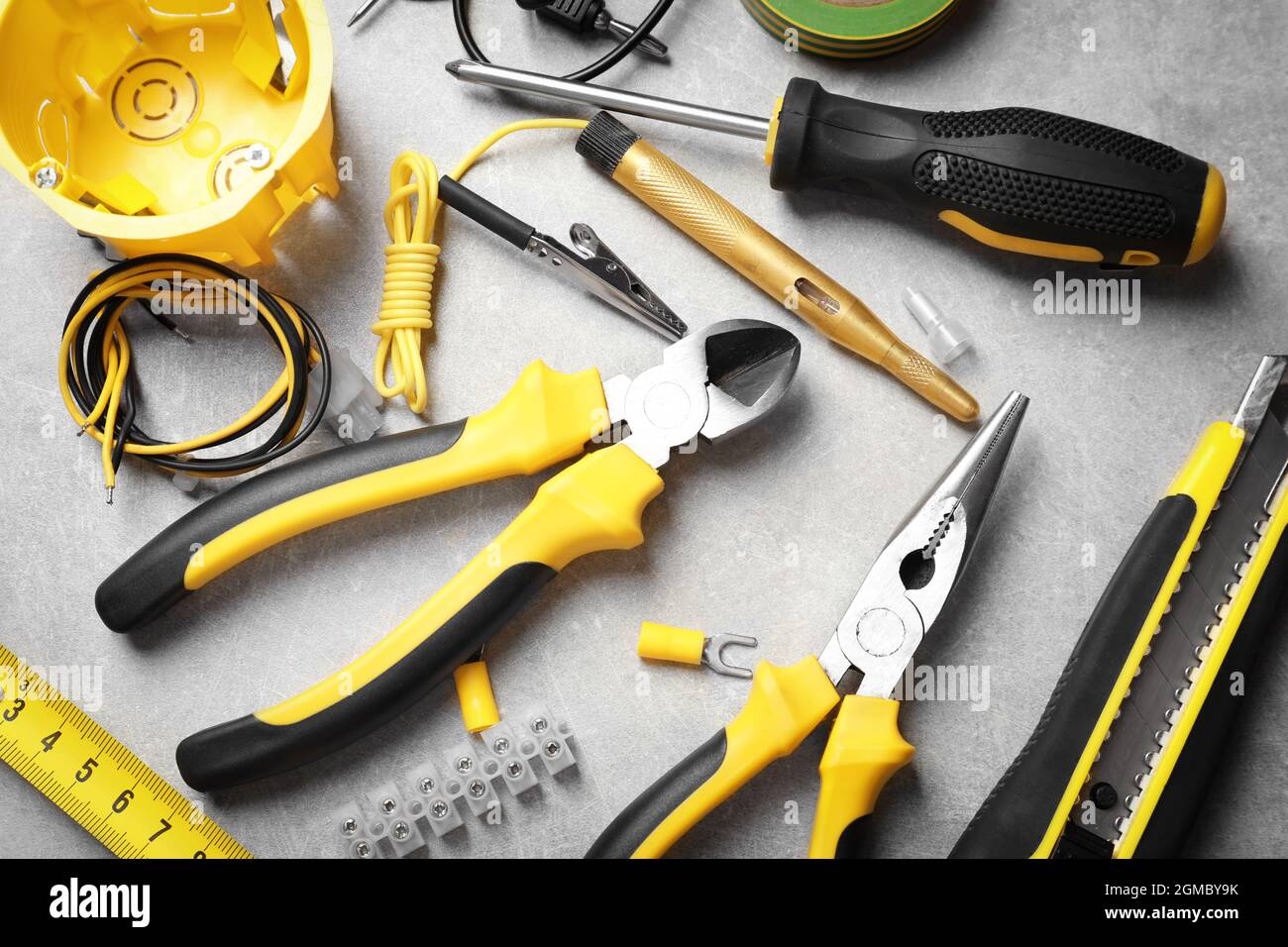 Different electrical tools on grey background Stock Photo - Alamy