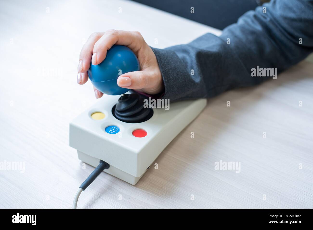 Woman with cerebral palsy works on a specialized computer mouse Stock ...
