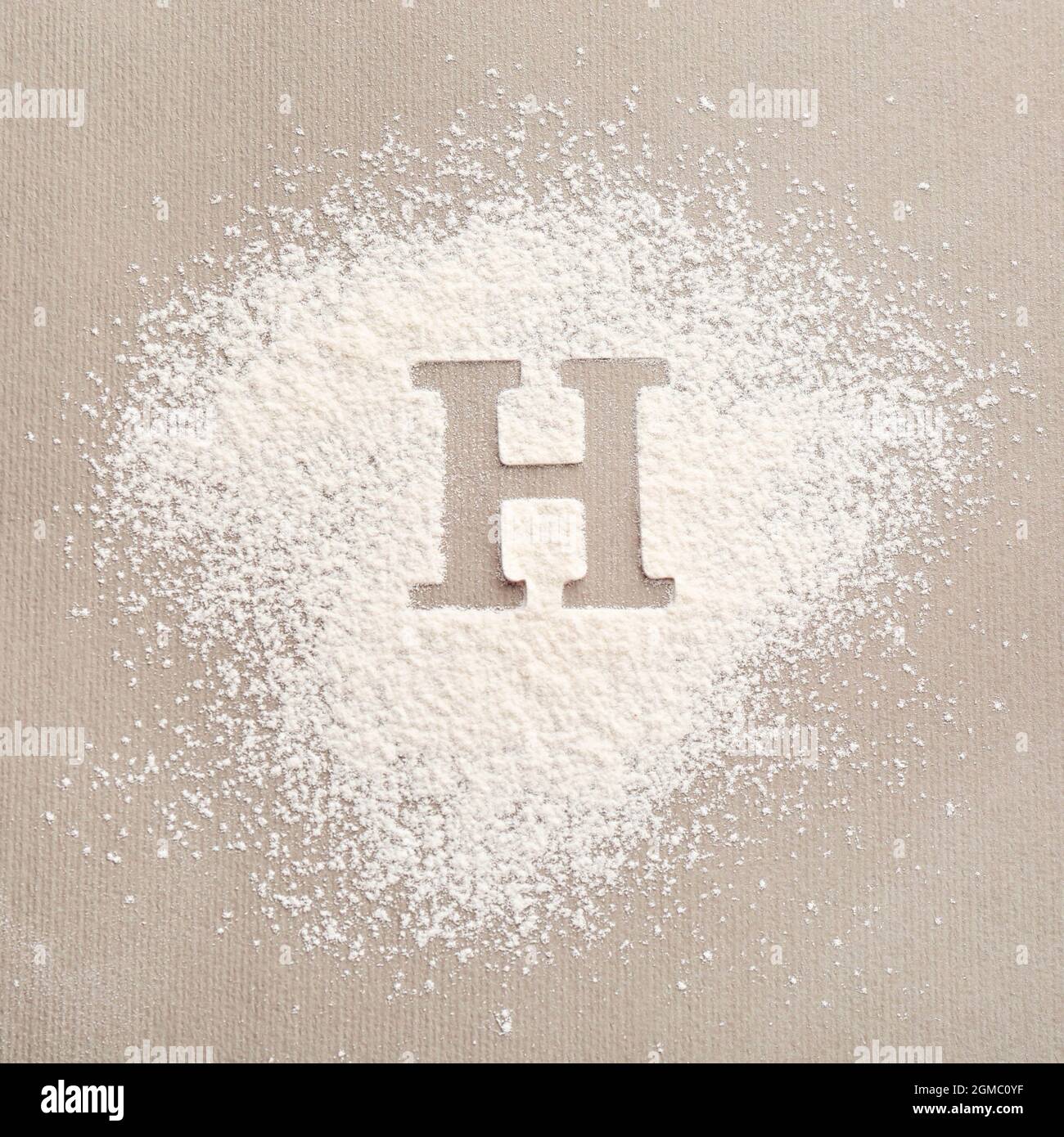 Silhouette of letter H on scattered flour Stock Photo - Alamy