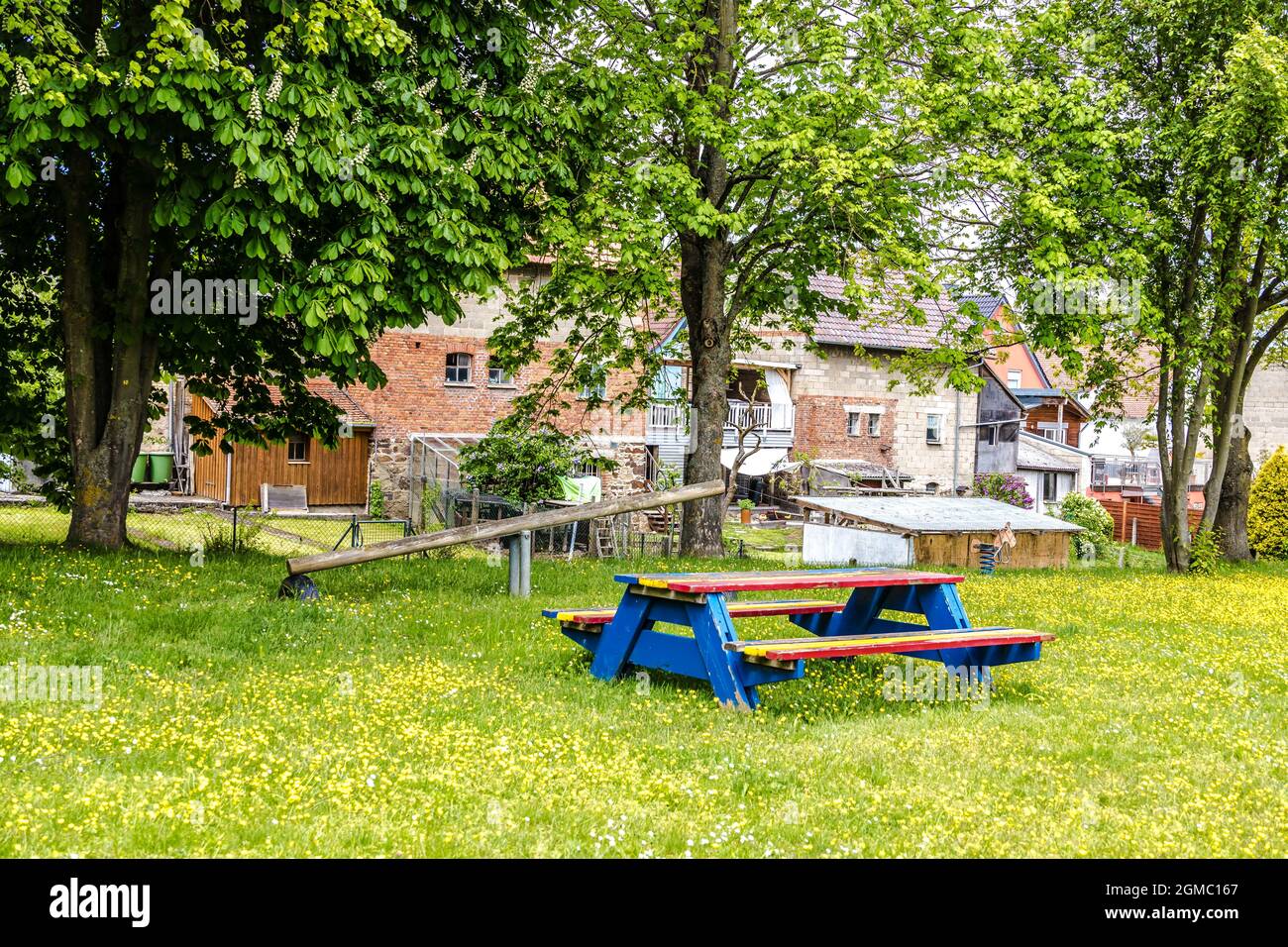 Outdoor bench with wooden table on a green meadow Stock Photo - Alamy