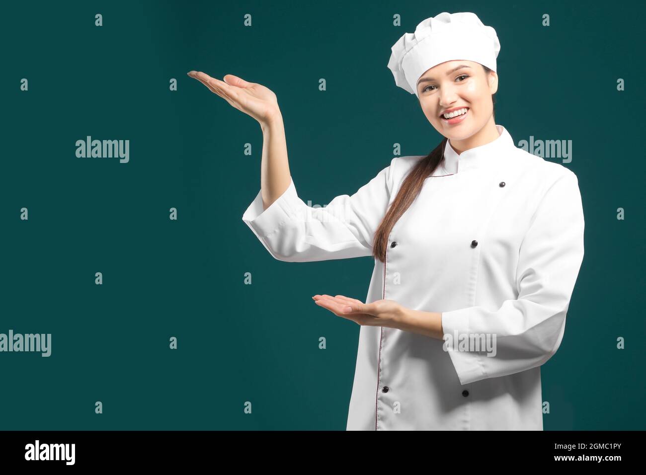 Beautiful female chef on color background Stock Photo - Alamy