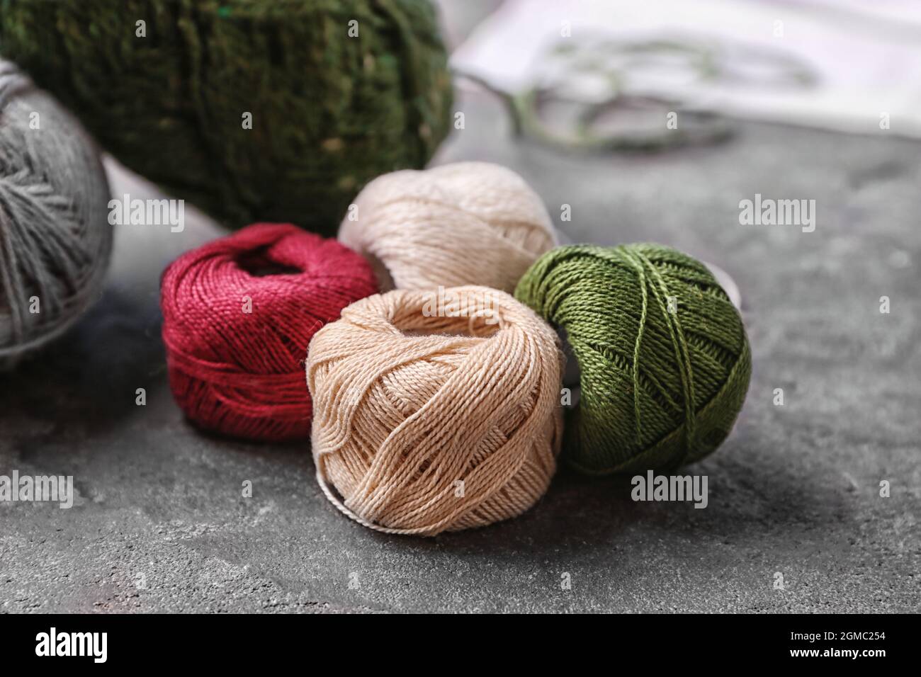 Colorful threads on grey background Stock Photo - Alamy