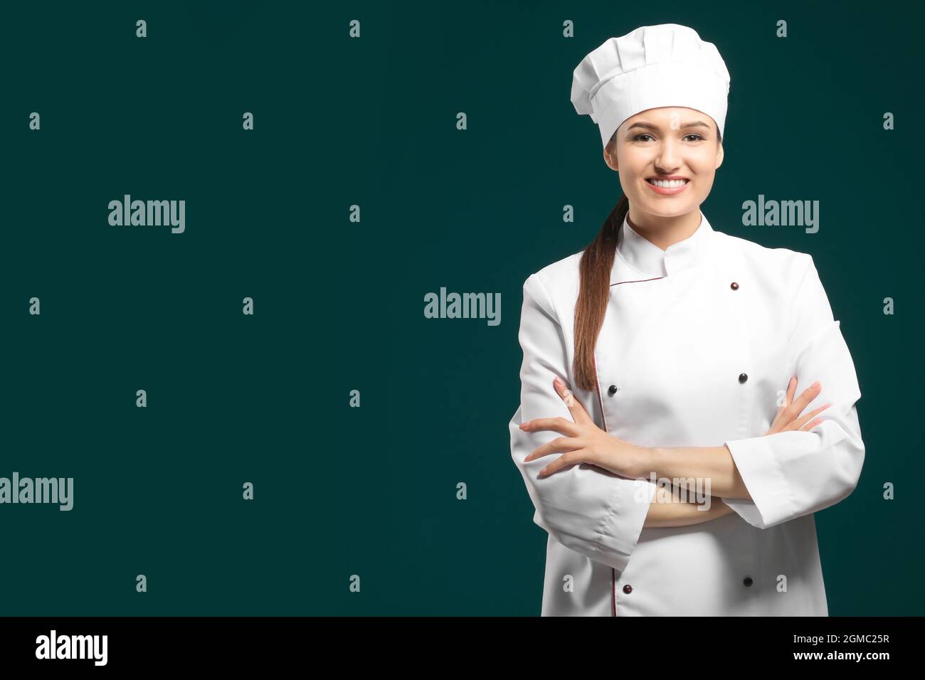 Beautiful female chef on color background Stock Photo - Alamy