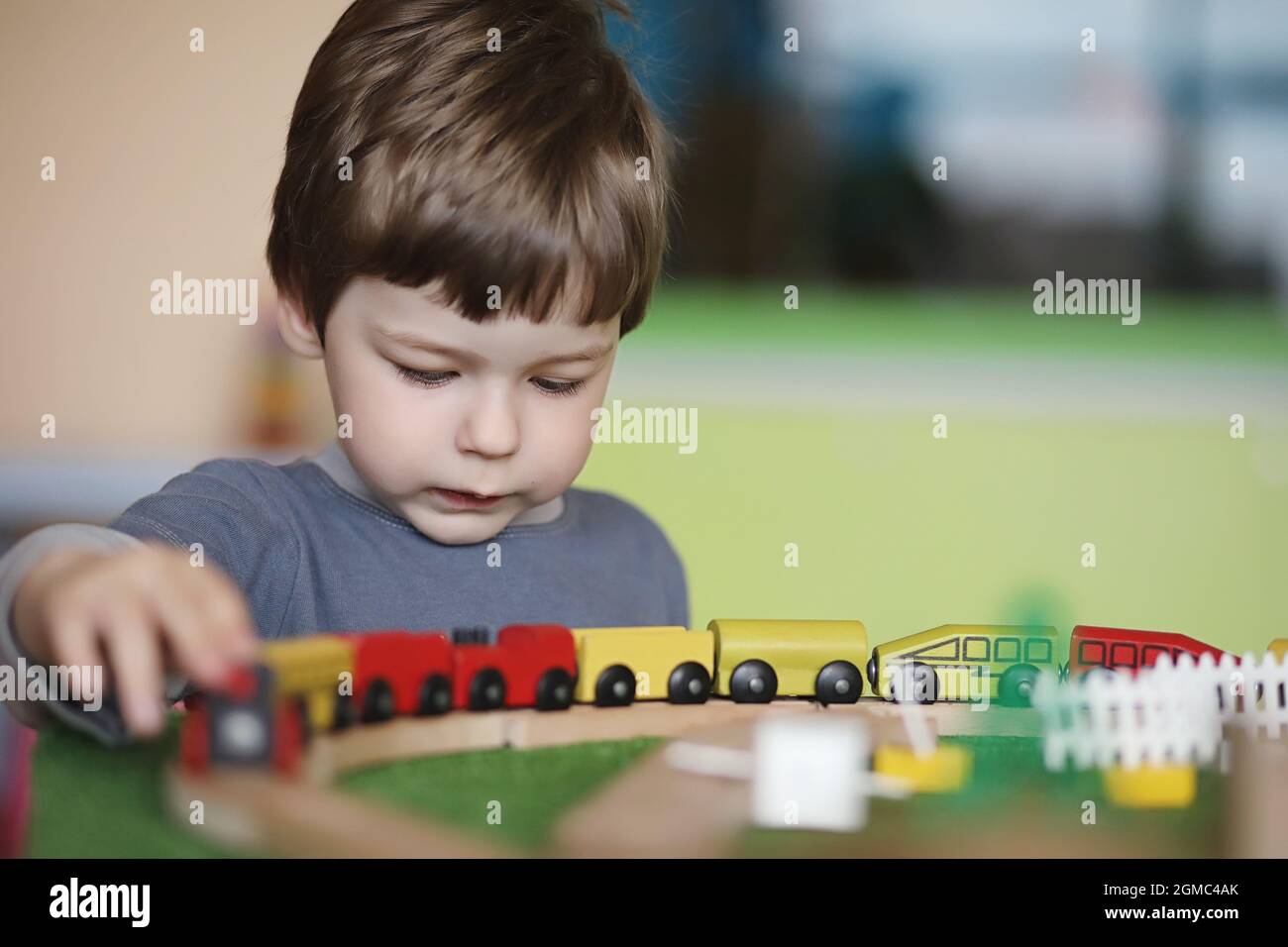 Child in the children's room. The kid is sitting on the windowsill at ...