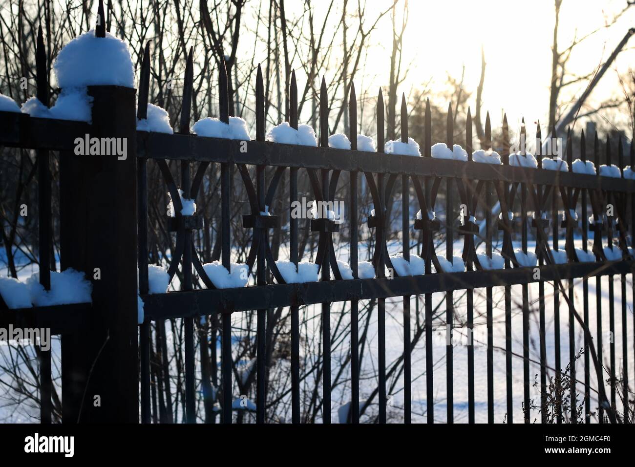 fence with spikes sun glare Stock Photo - Alamy