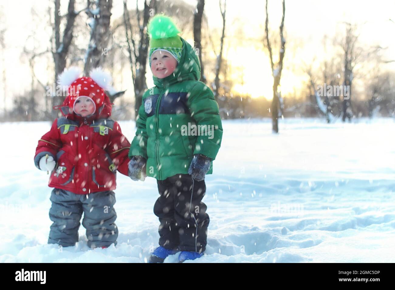 Family with children in the park in winter snow blizzard Stock Photo ...