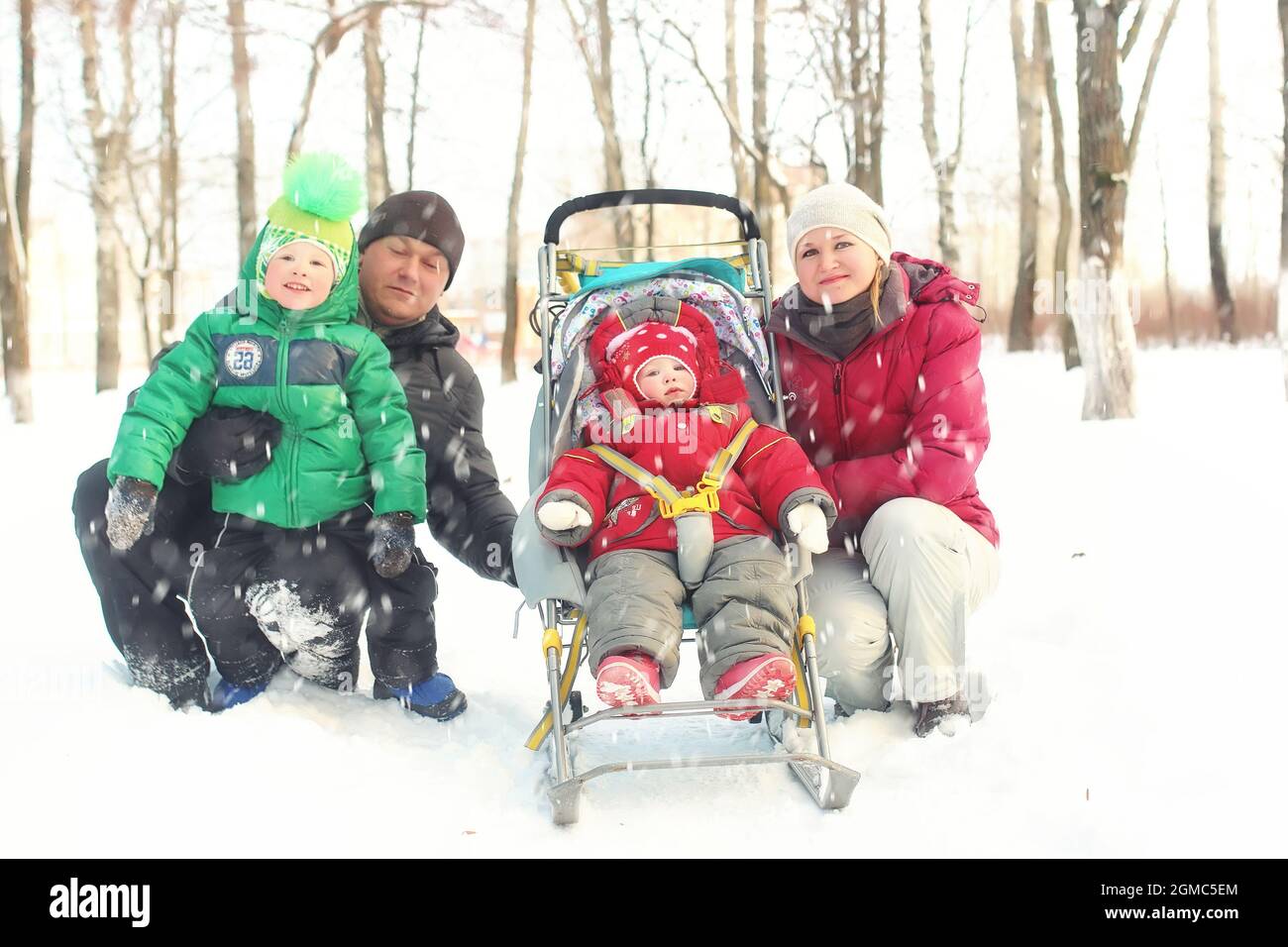 Family with children in the park in winter snow blizzard Stock Photo ...