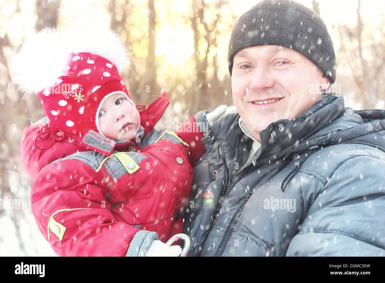 Family with children in the park in winter snow blizzard Stock Photo ...