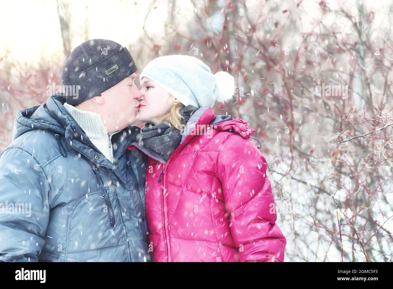 Family with children in the park in winter snow blizzard Stock Photo ...