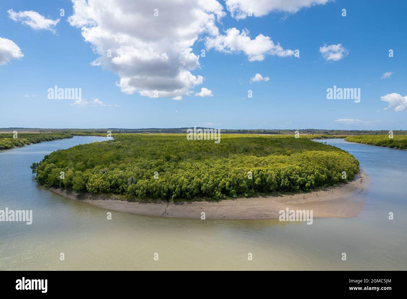 Clouds over country creek winding around thick green bushland forest ...