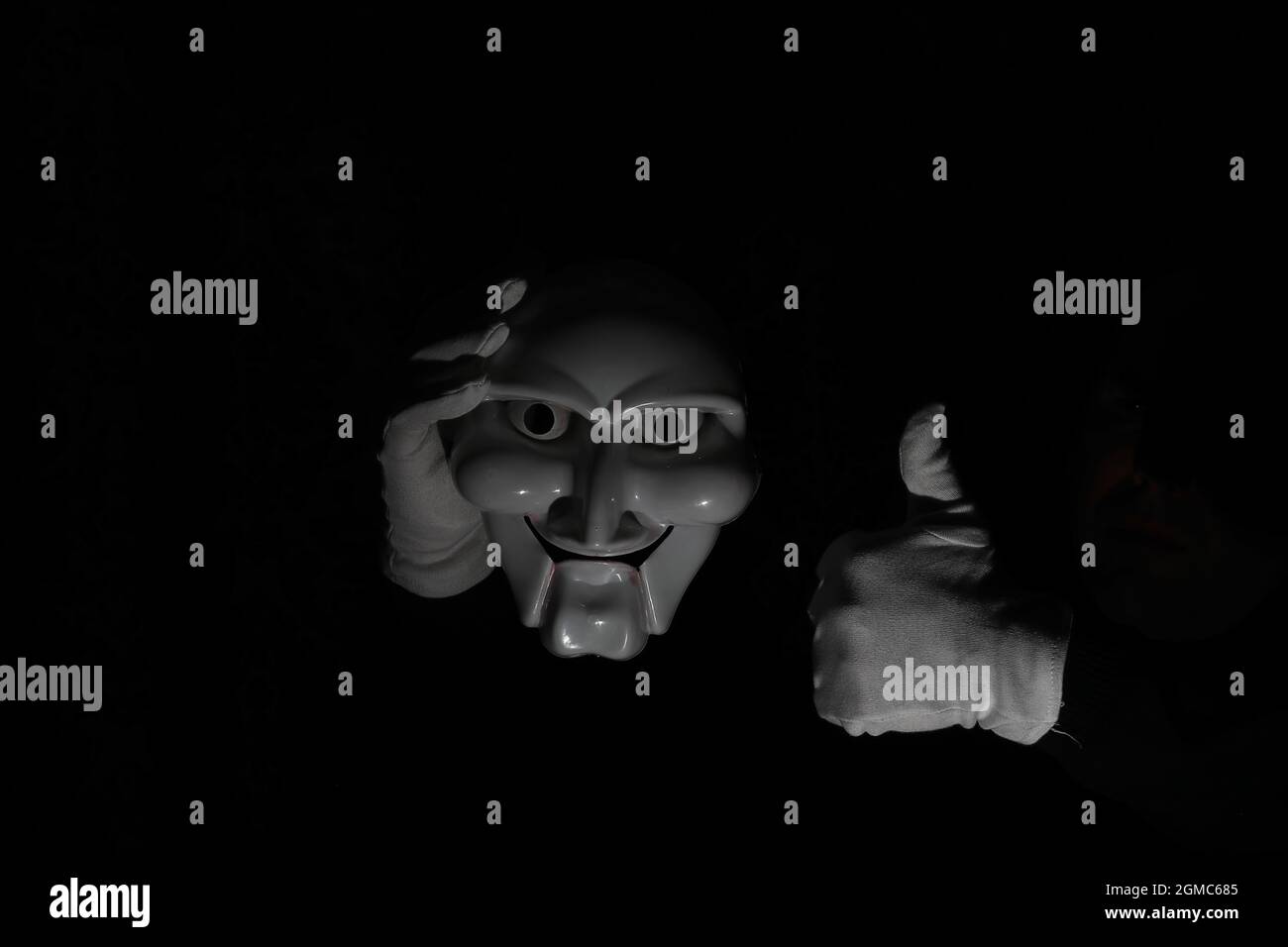 White scary mask on a black background with whites hands Stock Photo ...