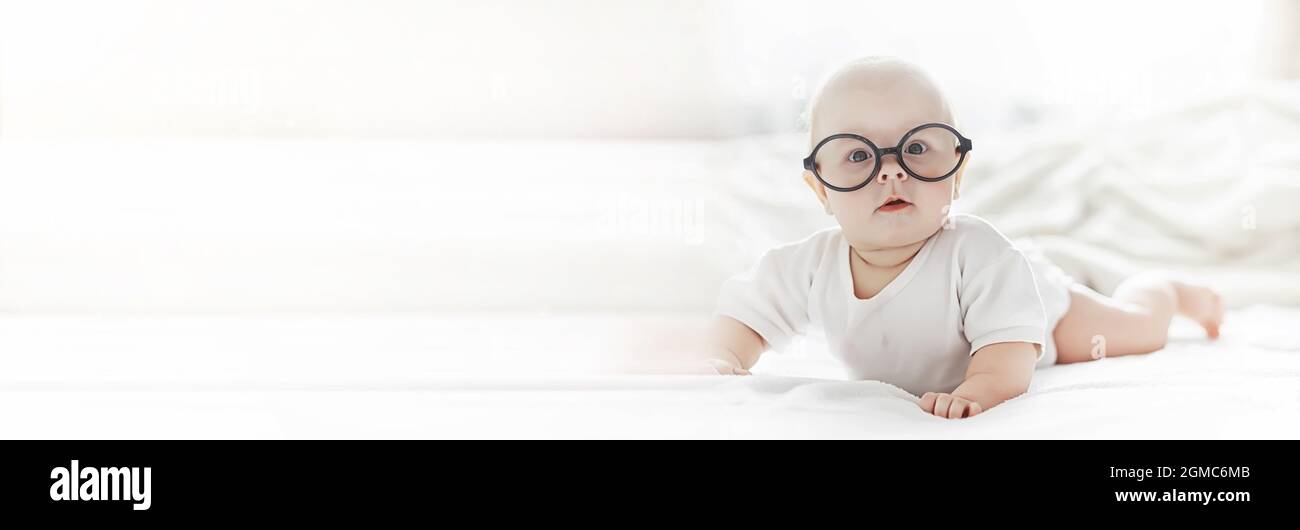 A newborn baby is lying on a soft bed. Children's emotions education ...